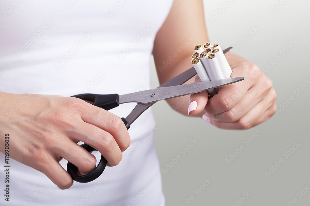 Quit smoking. Closeup of women's hands holding a bunch of cigarettes ...