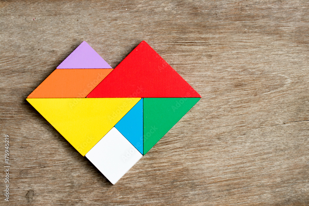 Colorful tangram puzzle in heart shape on wood background Stock Photo ...