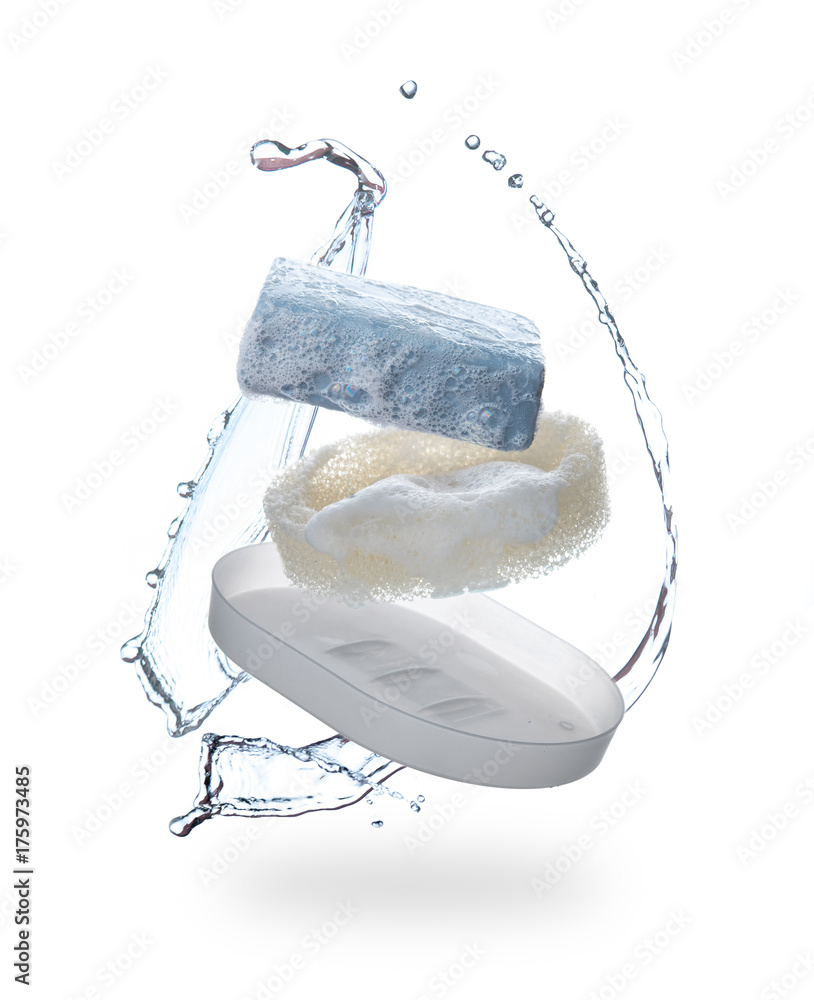 Flying pieces of Block carbon soap with foam and water splash on white ...