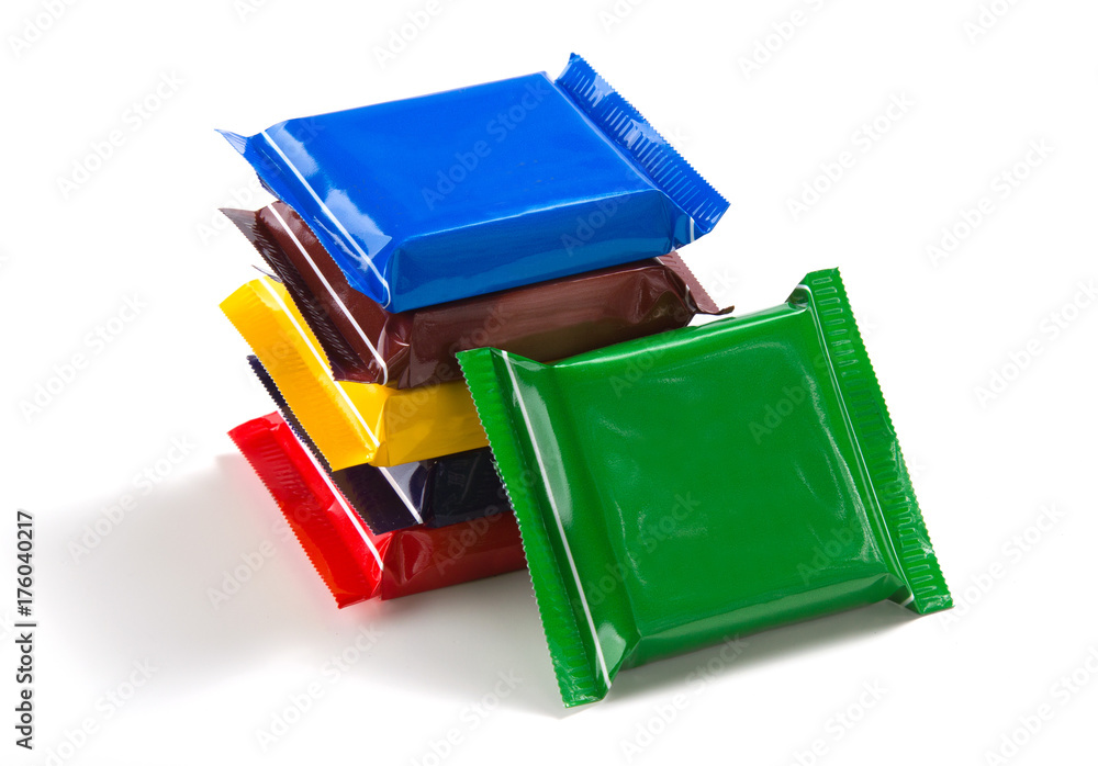 Square chocolate bars in multi-colored packaging on a white isolated ...