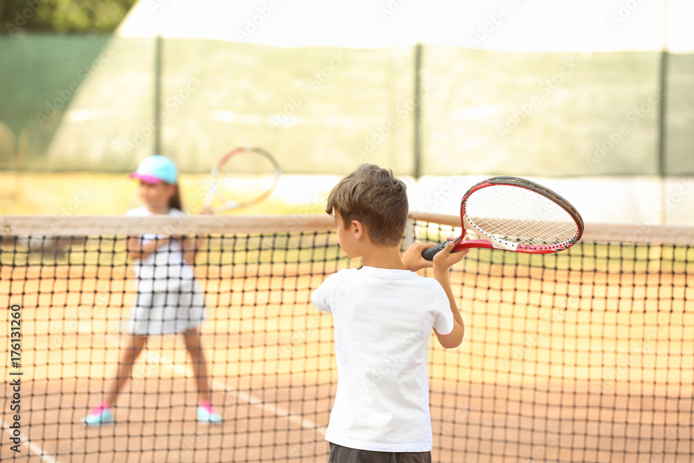 Cute little children playing tennis on court Stock Photo | Adobe Stock
