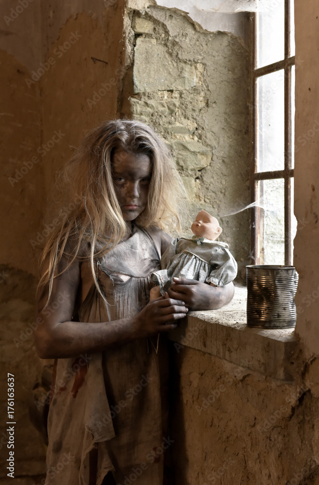 A scene of child poverty amongst children. The child is seen to be ...