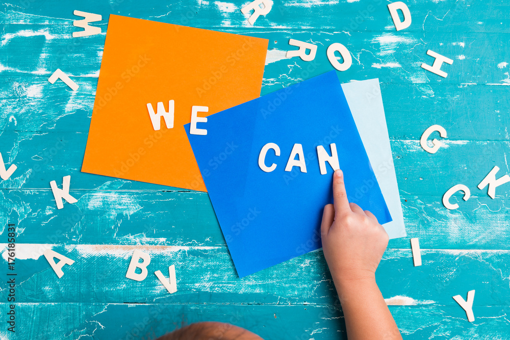 Children play wood letters to combinations word "WE CAN" . Stock Photo ...