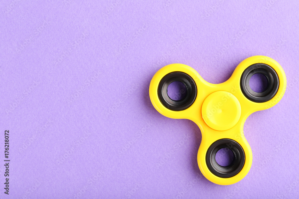 Fidget spinner toy on purple background Stock Photo | Adobe Stock