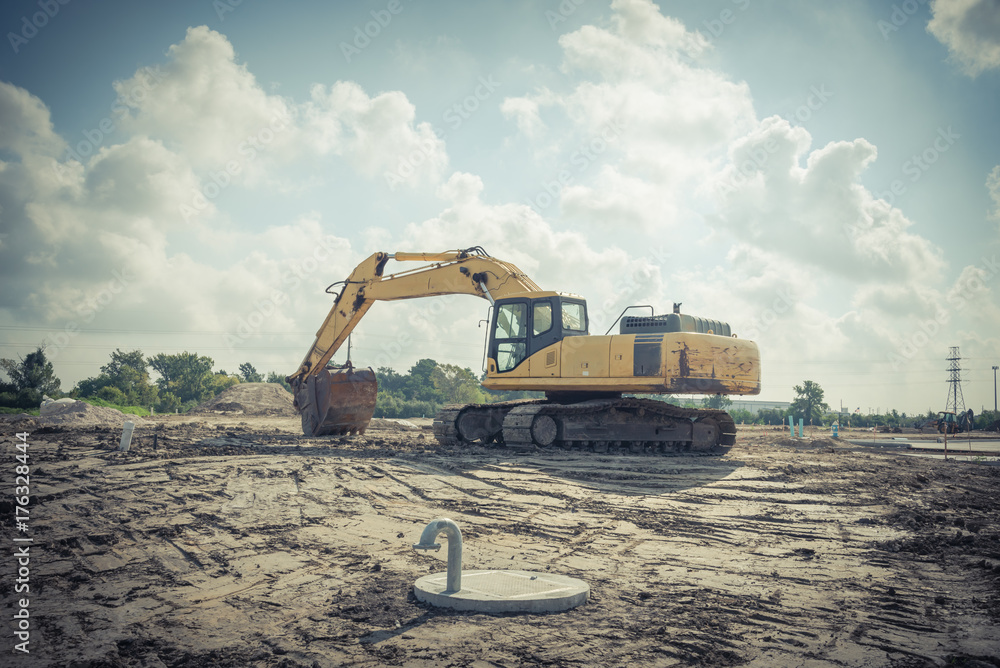 Excavator with digger standing for earthmoving works at construction ...
