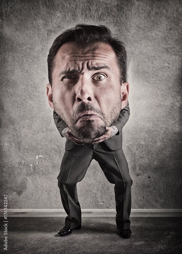 Man keeping his big head in hands. Strain concept. foto de Stock ...