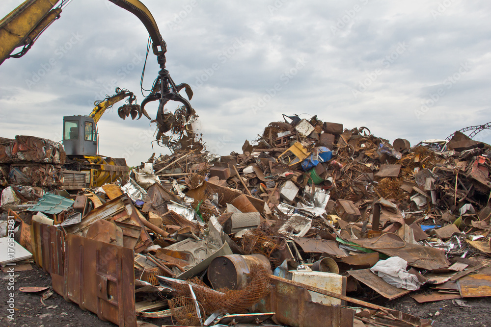 Sorting and loading of scrap metal./Excavator is loading scrap metal ...