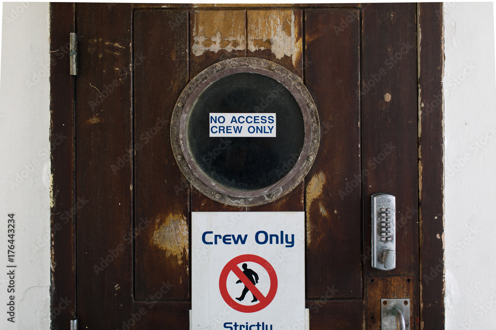 A "No access, crew only" sign on a door on the deck of a boat" "No ...