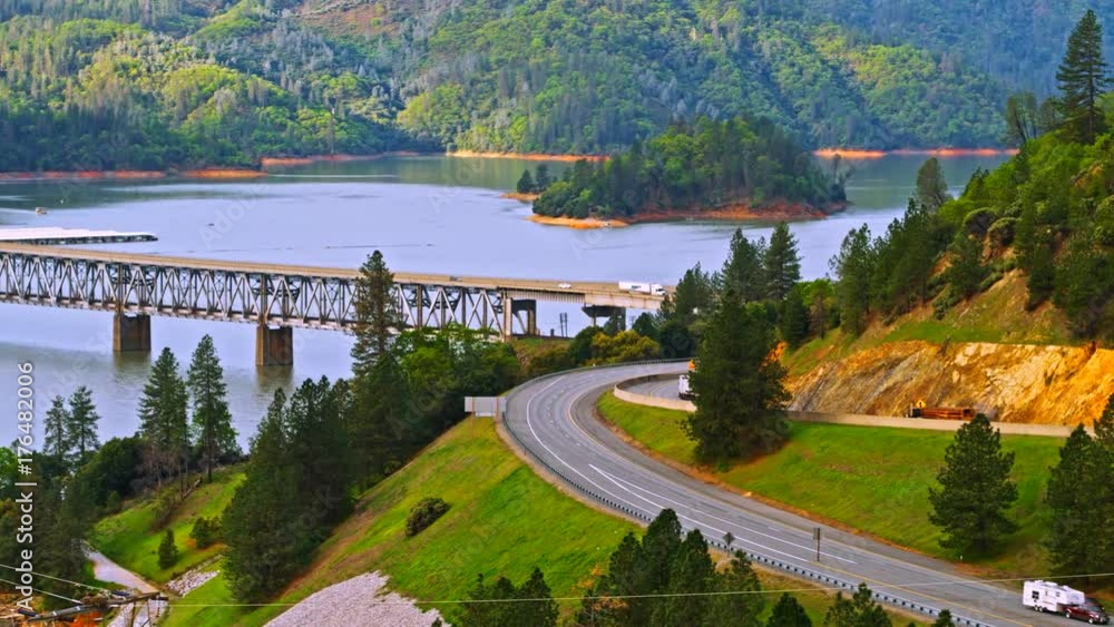 Vehicles driving on Pit River Bridge double deck road and rail bridge ...