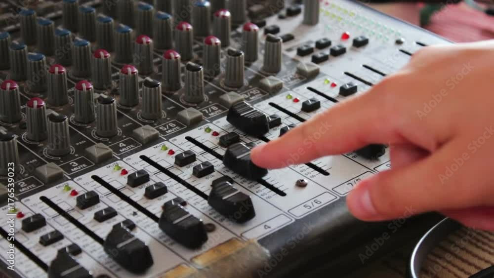 DJ console or mixer, the hand presses the levers and buttons of remote ...