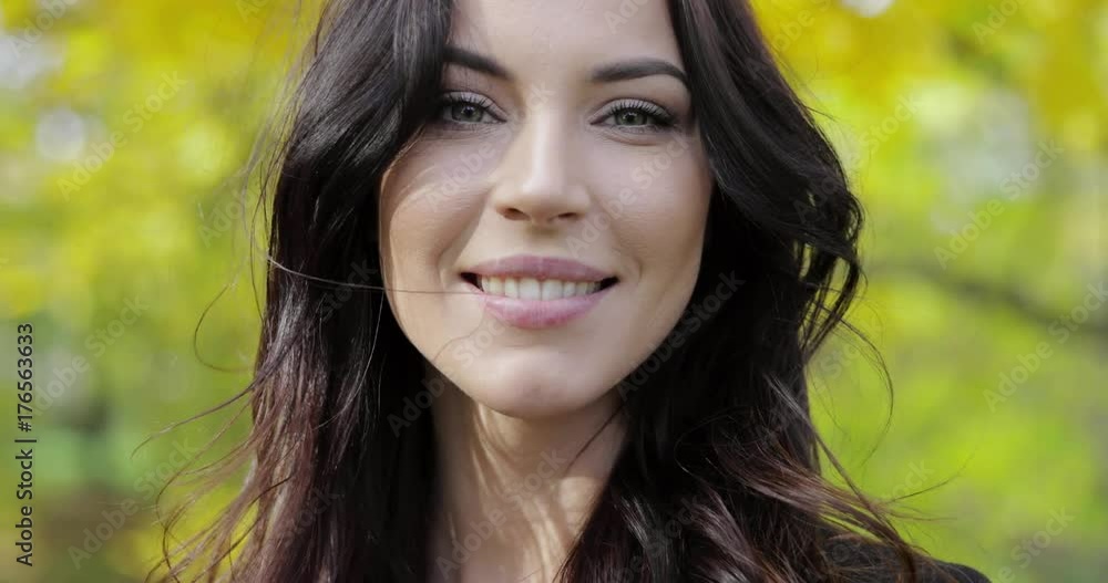 Pretty happy-looking woman looking at camera and smiling during her ...