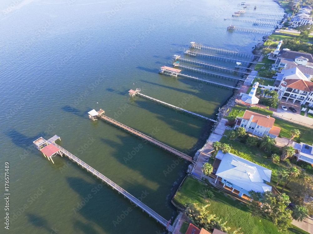 Aerial view three-story waterfront vacation home with fishing piers ...