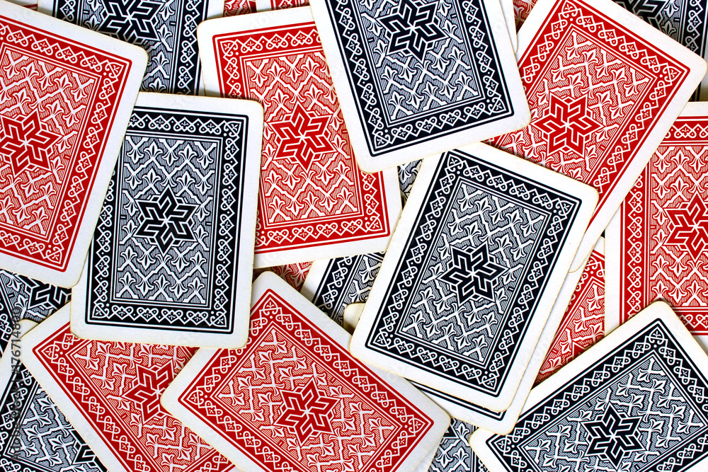 Texture of red and blue playing cards back spread on a table Stock ...