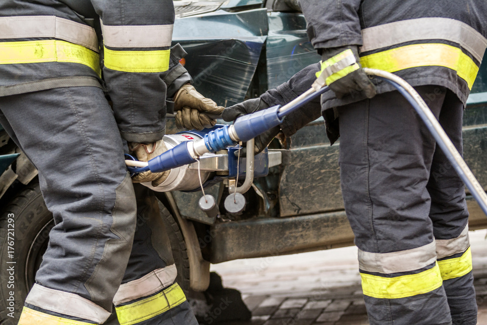 Firefighters working on an auto vehicle extrication with a hydraulic ...