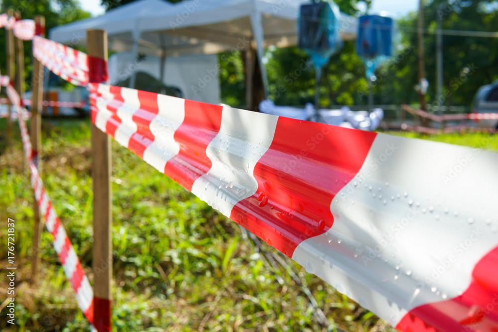 Red and white tripped tape fence for barricades or murder zones or ...