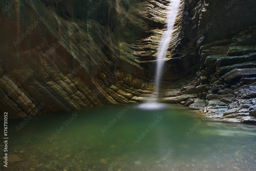 Marvellous grotto with a flowing beautiful waterfall Stock Photo ...