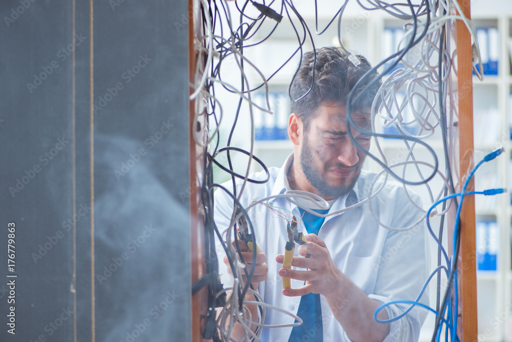 Electrician trying to untangle wires in repair concept Stock Photo ...