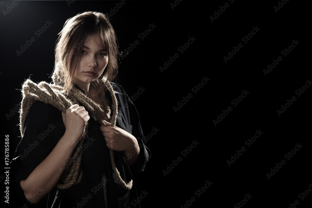 woman executioner with wrap on black background Stock Photo | Adobe Stock