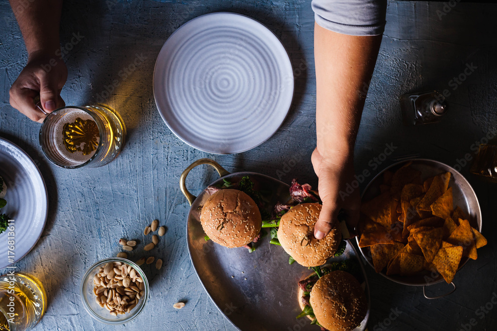 Table bar drinking beer eating hamburger beef skirts veggies burger ...