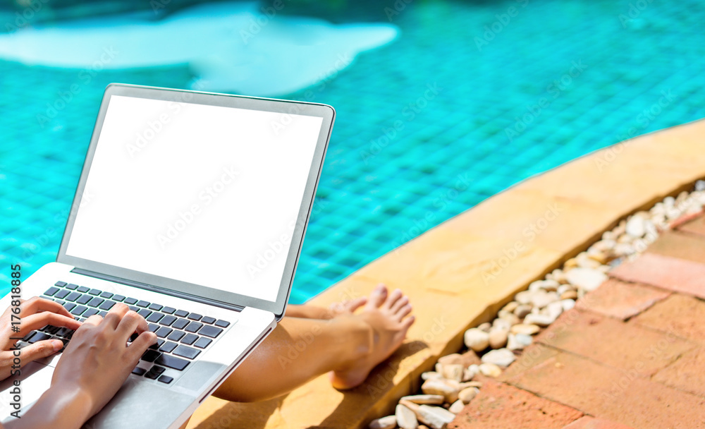 Woman bikini using laptop computer blank screen at swimming pool in ...