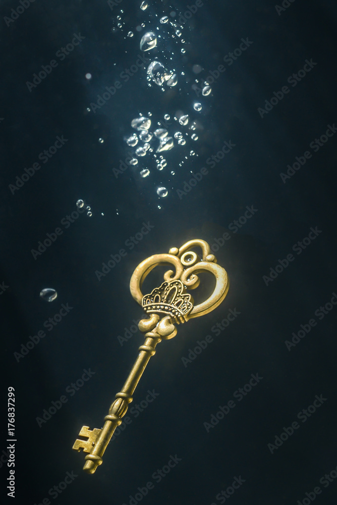 Vintage key under water. Stock Photo | Adobe Stock