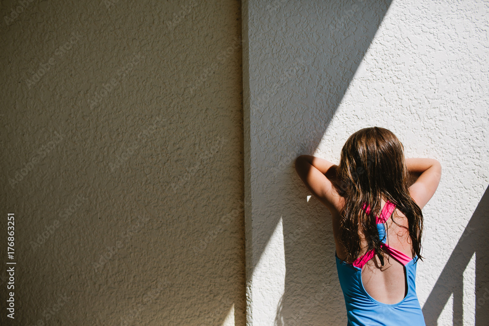 little girl facing a wall Stock Photo | Adobe Stock