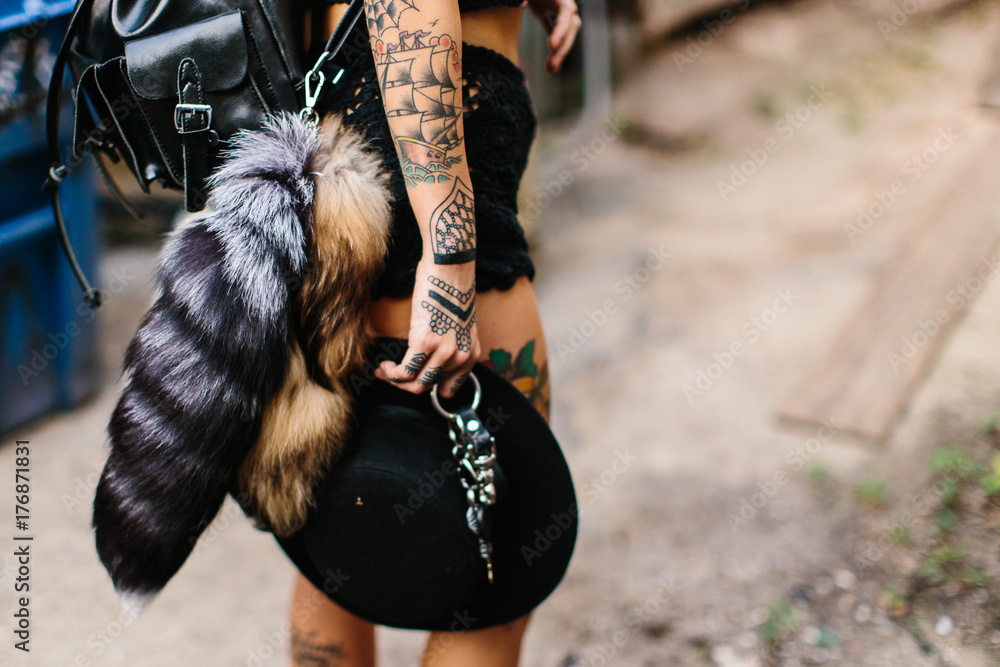 A woman wearing two furry fox tails on her waist Stock Photo | Adobe Stock