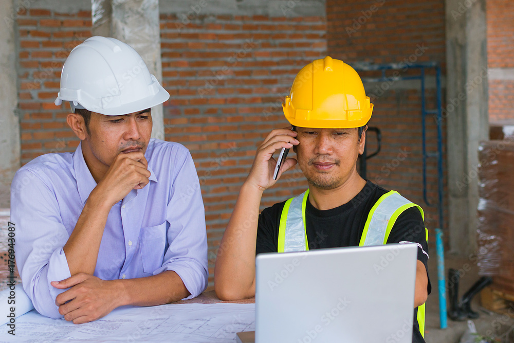 engineer and construction team working on checking progress of ...