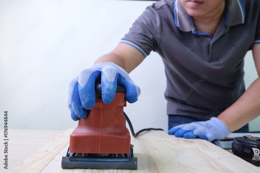 Carpenter using sander machine sanding on pine wood surface Stock Photo ...