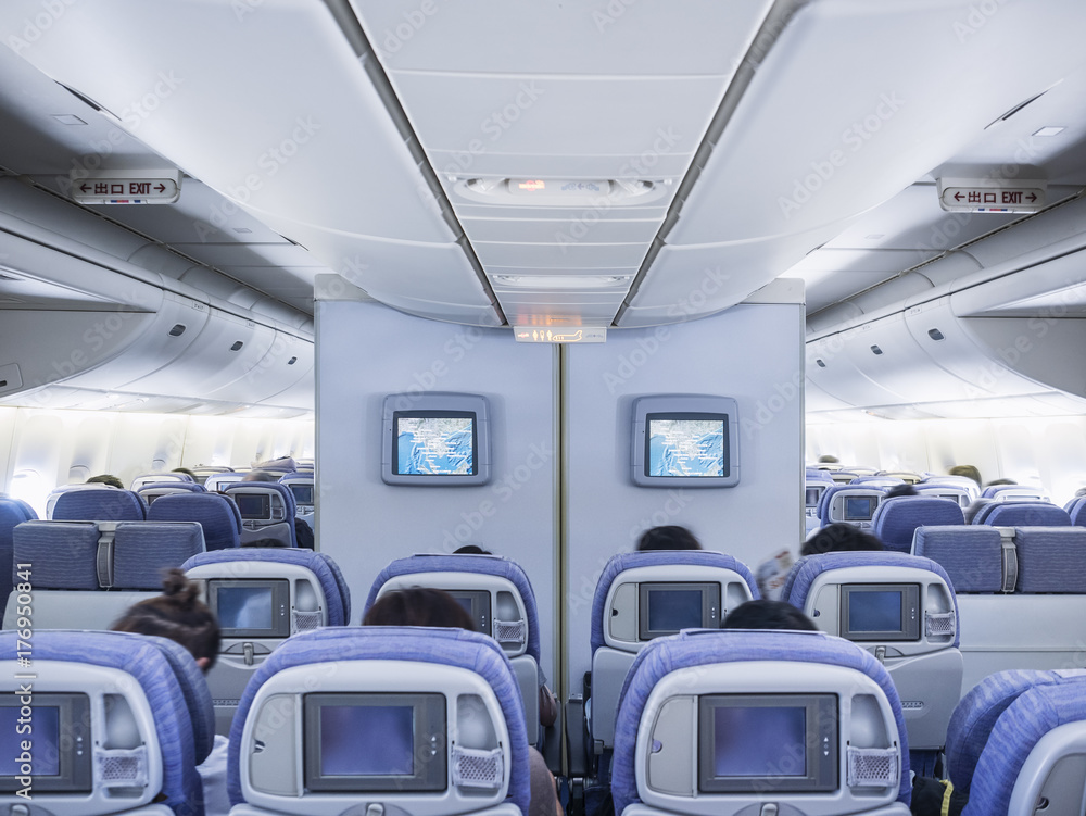 Airplane Interior flight on board with seat row and front screen ...