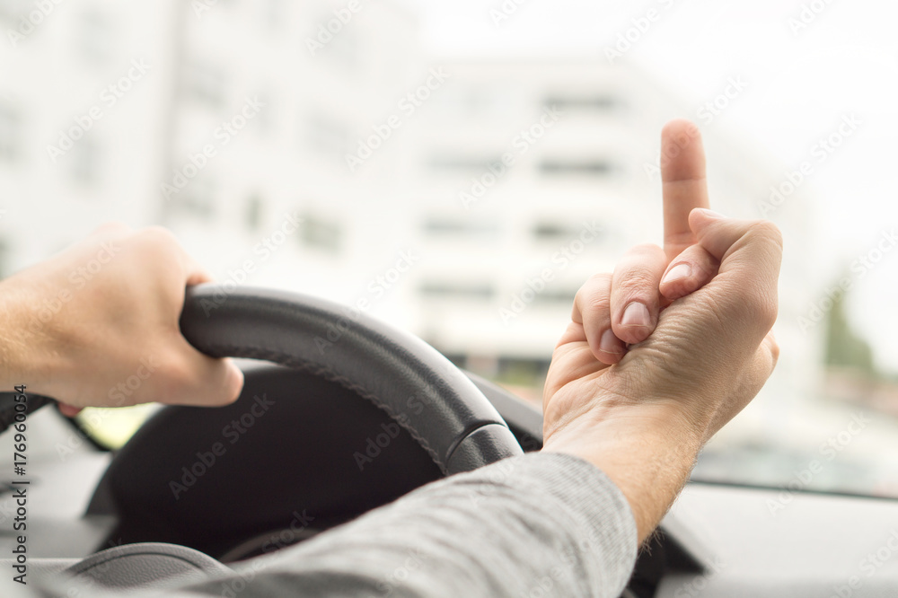 Foto de Road rage. Man driving and showing middle finger in car. Driver ...