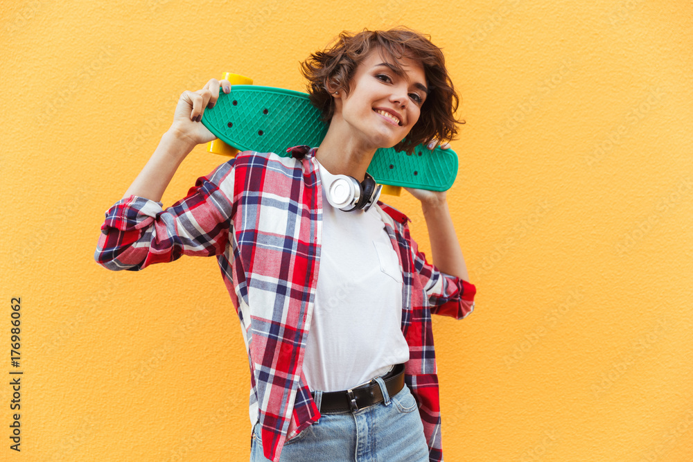 Happy Pretty Teenage Girl Holding Skateboard On Her Shoulders Stock