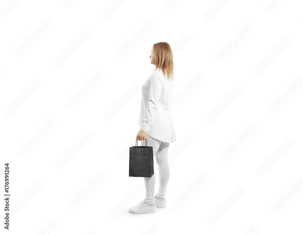 Women holding blank black craft paper bag design mock up in hand. Woman ...