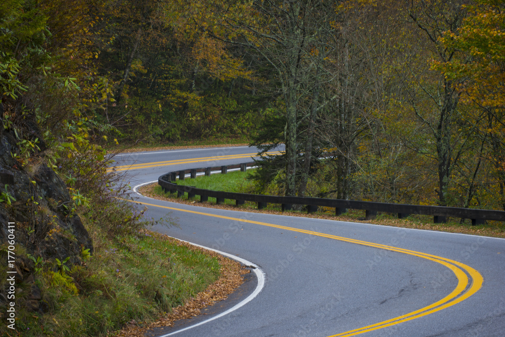 Twisting curvy road winding through fall colorful trees in national ...