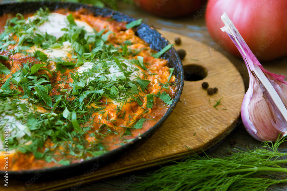 Shakshuka - jewish traditional recipe. Breakfast with fried eggs ...