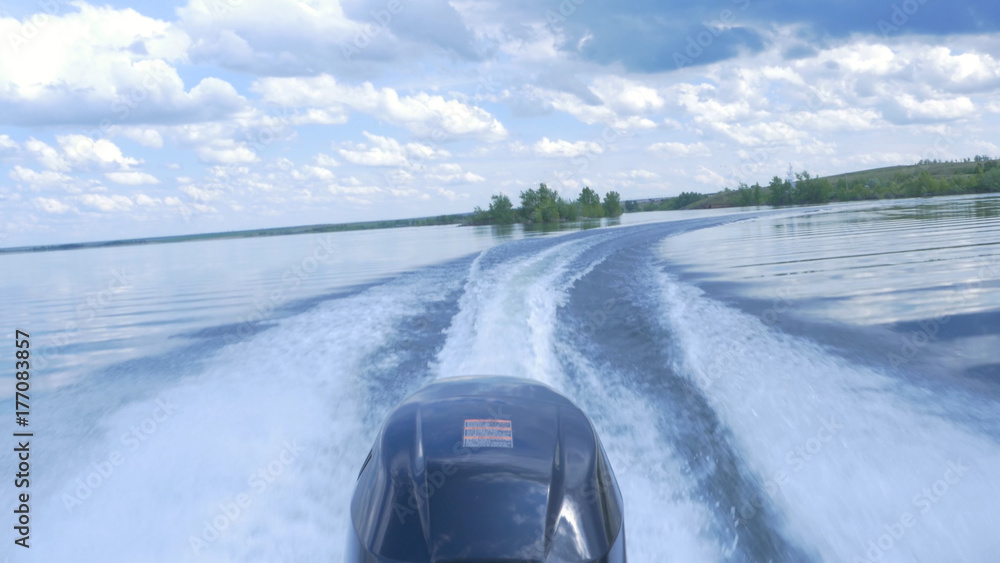 Trail on water surface behind of fast moving motor boat. the motor of ...