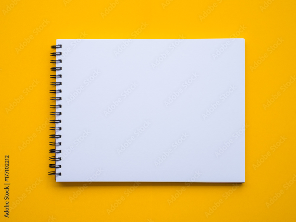Notepad on yellow background Stock Photo | Adobe Stock