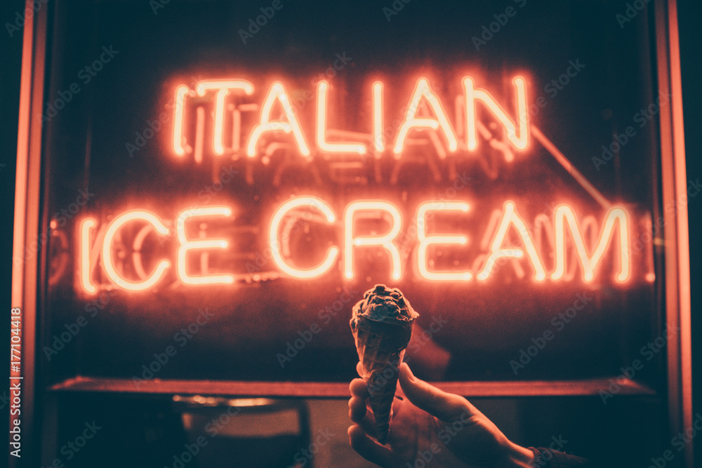 Board sign saying Italian Ice Cream with hand holding ice cream cone ...