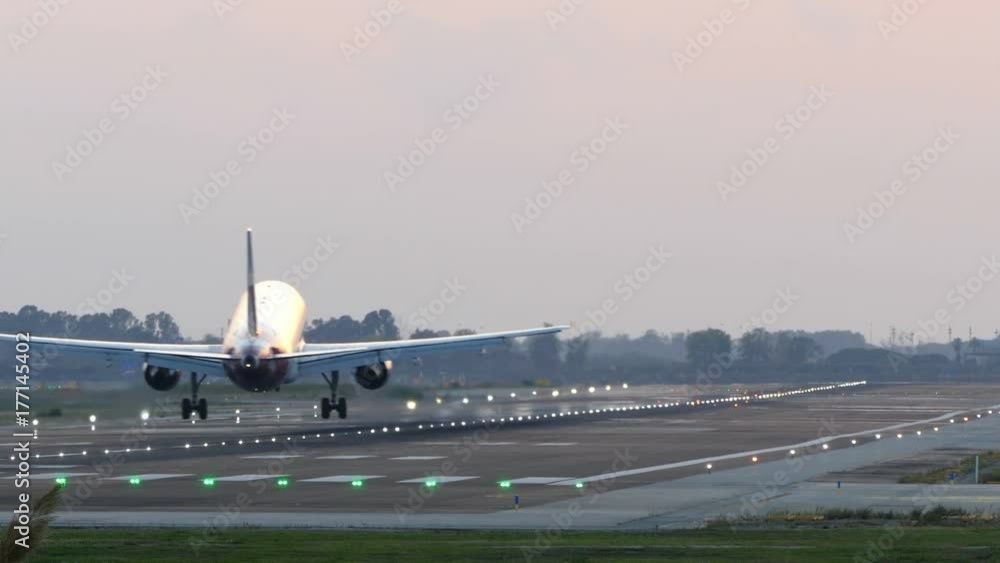 Big plane landing at Barcelona airport seen from behind at sunset with ...