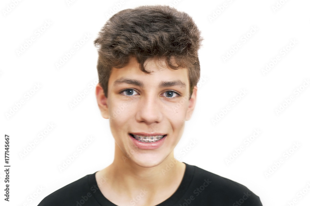 Cute guy on a white background. On his teeth, after visiting the ...