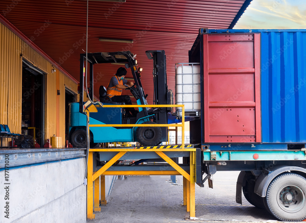 Forklift unstuffing tank of solvent from container to storange in ...