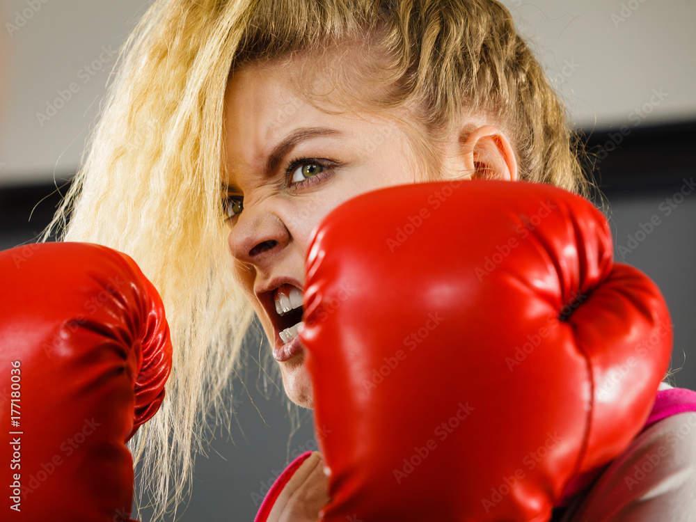 Angry woman wearing boxing gloves Stock Photo | Adobe Stock