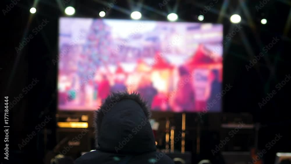 People watching clips of upcoming celebration on big screen in central ...