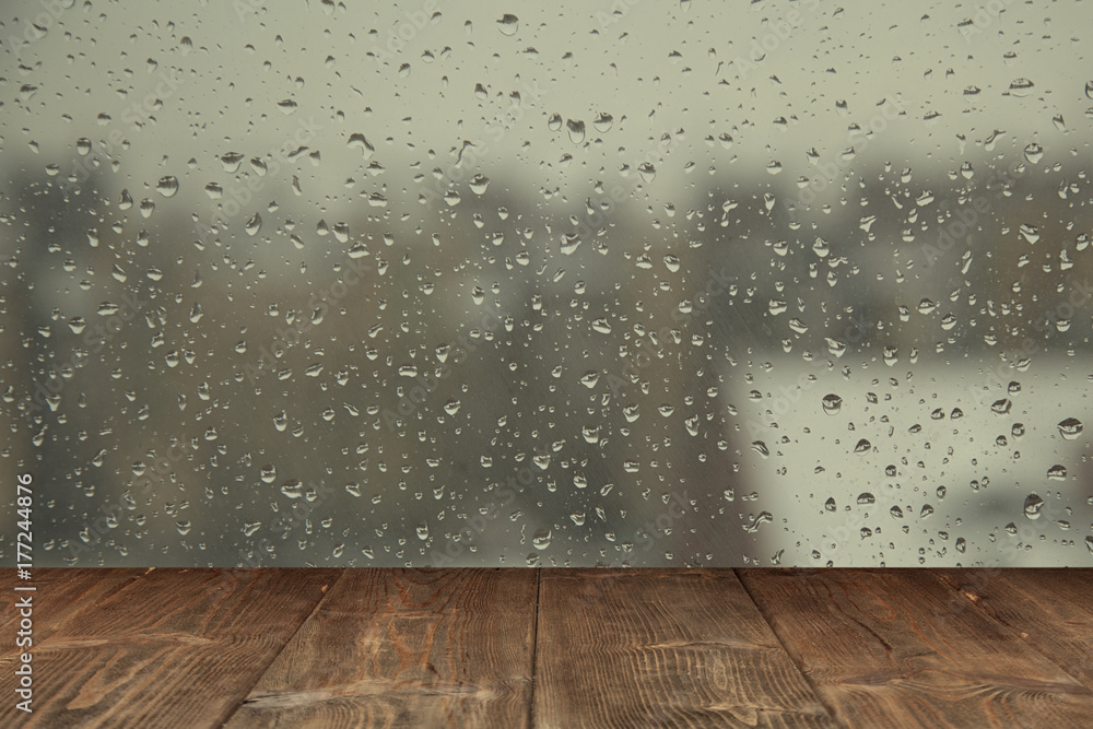 Table on rainy window background Stock Photo | Adobe Stock