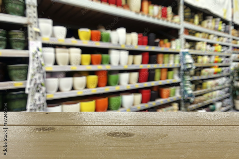 Store pottery in the supermarket, defocused image. Wooden table top or ...