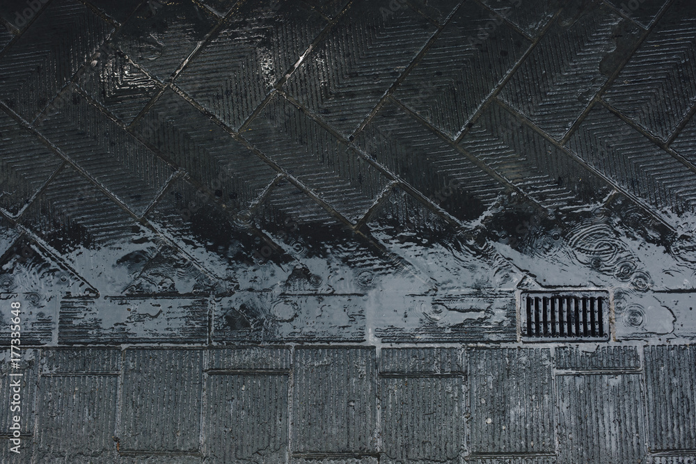 Wet pavement on the street in the rain with a drain Stock Photo | Adobe ...
