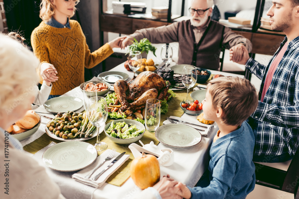 family holding hands and praying on thanksgiving Stock Photo | Adobe Stock