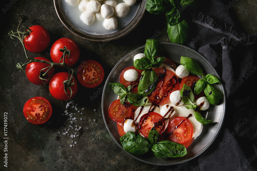 Italian caprese salad with sliced tomatoes, mozzarella cheese, basil ...
