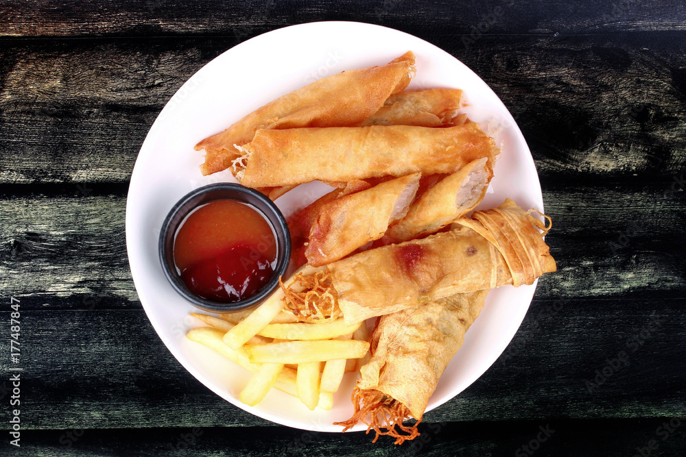 Deep fried spring roll,and frence fries sreved with tomato souce and ...