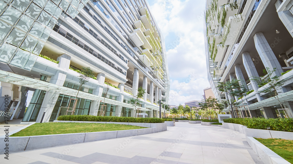 Low angle perspective view of empty pavement and modern office building ...